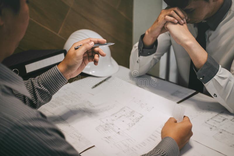 Construction Engineering or Architect Discuss a Blueprint while ...