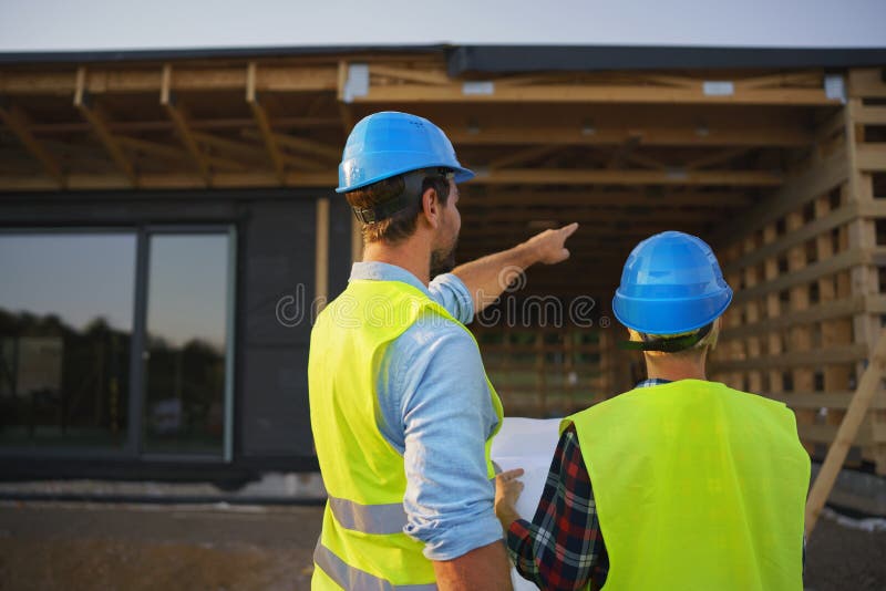 Construction Engineers or Architects with Blueprints Checking Eco ...