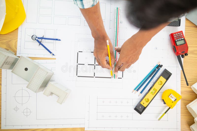 Construction Engineers are Checking Blueprints and Calculating Their ...