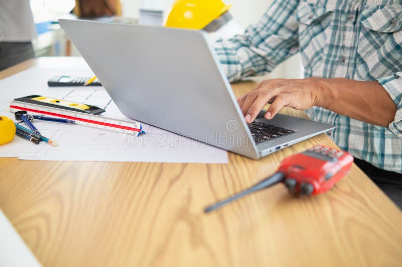 Construction Engineers are Checking Blueprints and Calculating Their ...