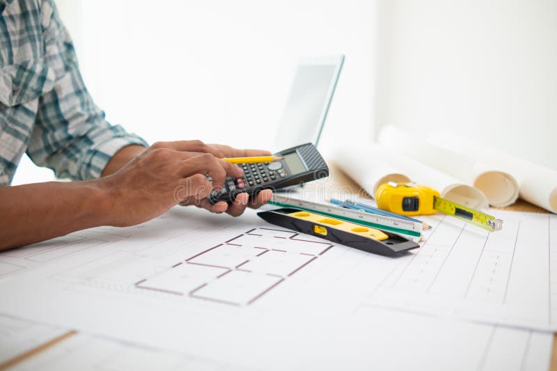 Construction Engineers are Checking Blueprints and Calculating Their ...