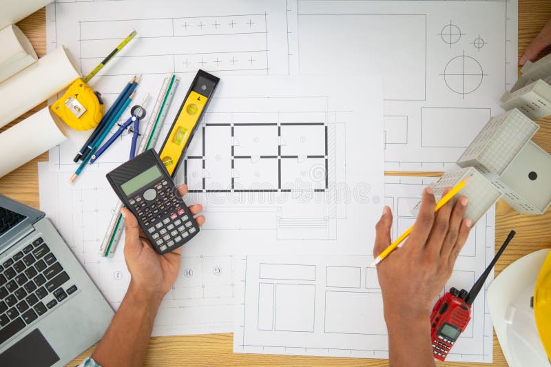 Construction Engineers are Checking Blueprints and Calculating Their ...