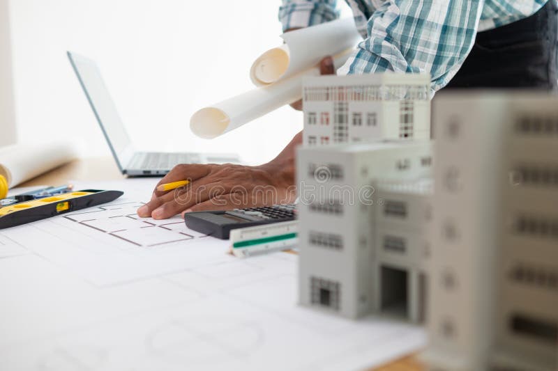 Construction Engineers are Checking Blueprints and Calculating Their ...