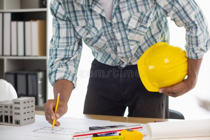 Construction Engineers are Checking Blueprints and Calculating Their ...
