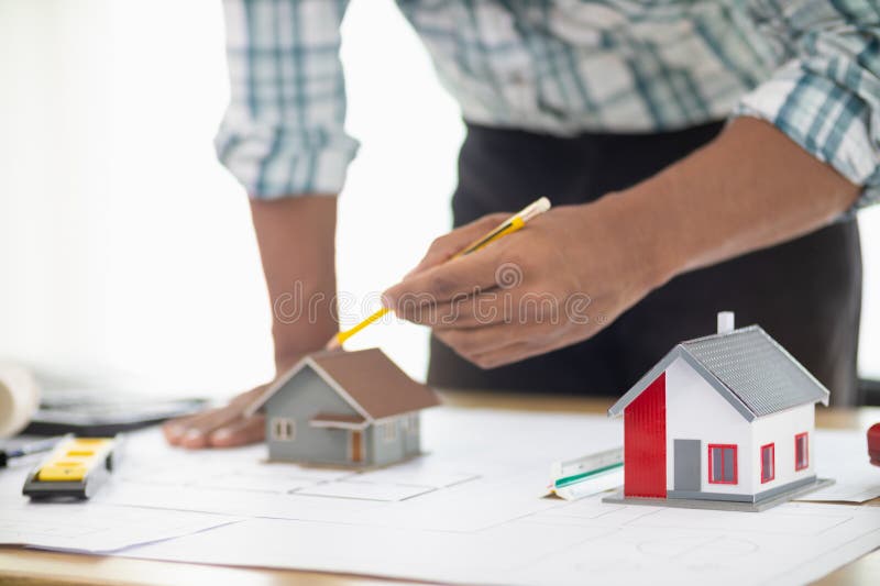 Construction Engineers are Checking Blueprints and Calculating Their ...