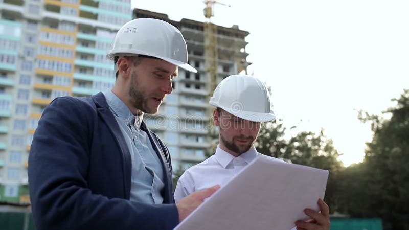 Construction Engineers Look at Building Plans Stock Footage - Video of ...