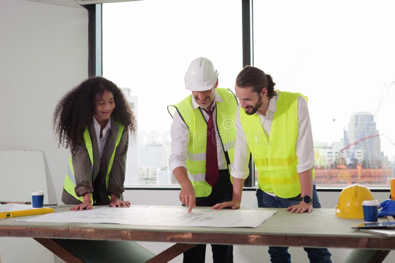 Construction Engineers Team Using Blueprint of Project Plan Stock Photo ...