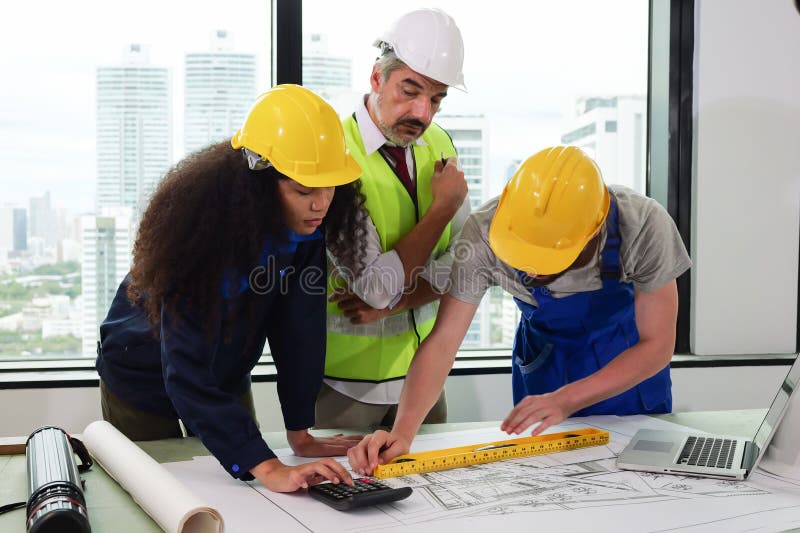 Construction Engineers Team Using Blueprint of Project Plan Stock Photo ...