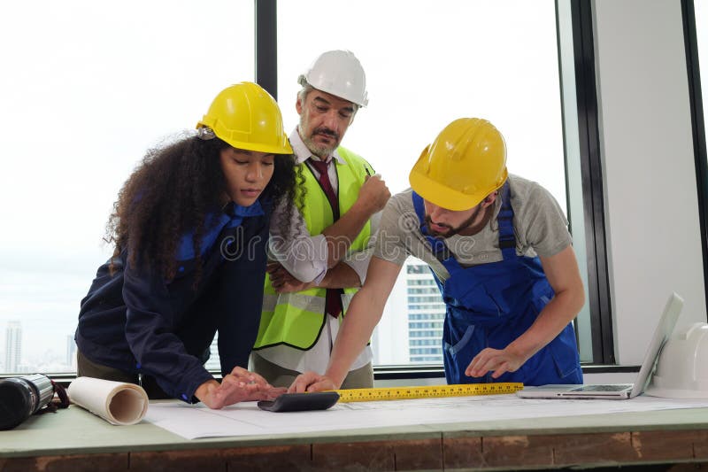 Construction Engineers Team Using Blueprint of Project Plan Stock Photo ...