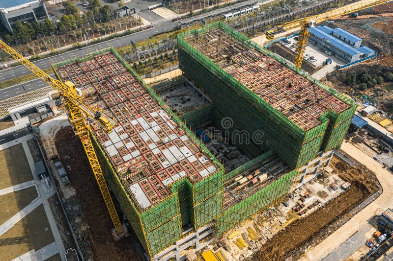 Construction Equipment and Equipment Sit in Front of a Large Building ...