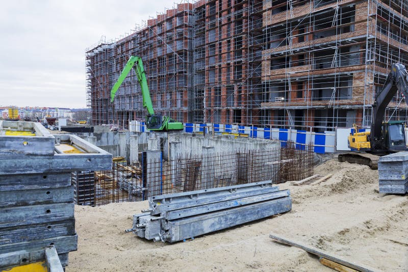 A Construction Excavator and a Multi-storey Fortified Building Under ...