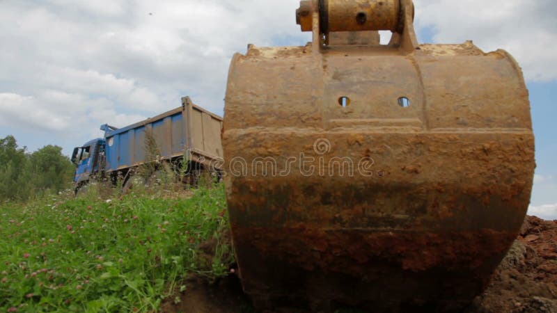 Construction Excavator Scooping and Dumping on Dirt Pile Stock Footage ...