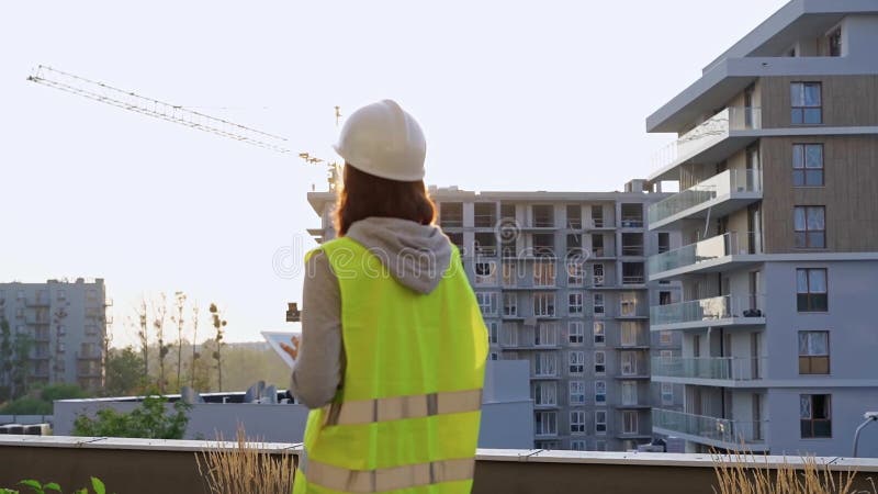 Construction Female Engineer Taking Notes and Tapping on Tablet ...