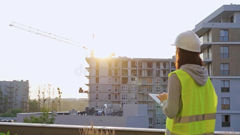 Construction Female Engineer Taking Notes and Tapping on Tablet ...