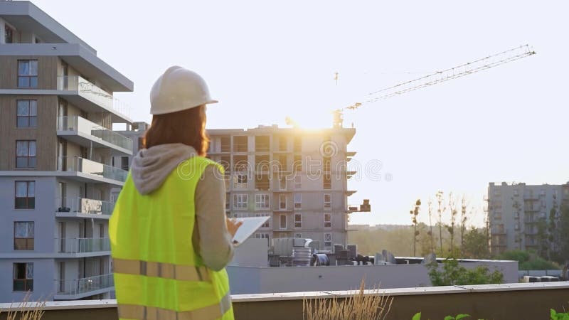 Construction Female Engineer Taking Notes and Tapping on Tablet ...