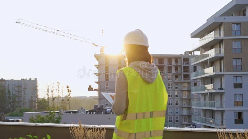 Construction Female Engineer Taking Notes and Tapping on Tablet ...