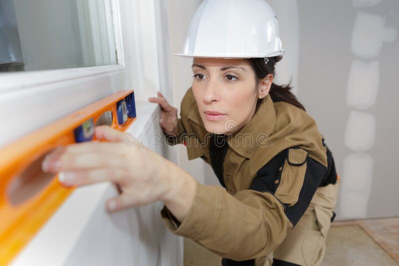 Construction Female Worker Using Level Tool on House Wall Stock Image ...