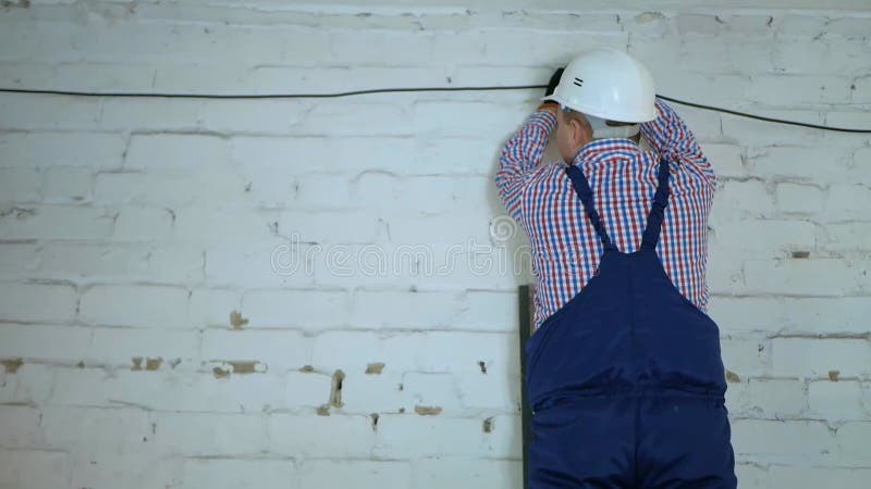 Construction of a Fiber Optic Communication Line Along the Wall. Stock ...