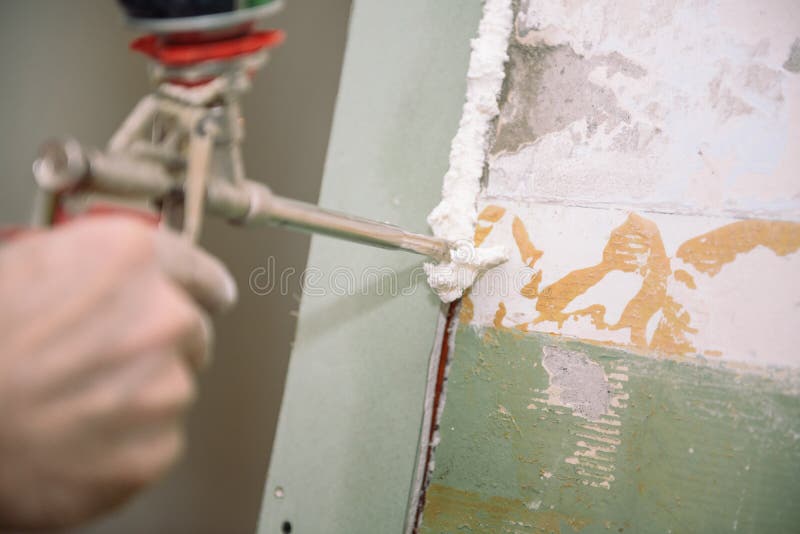 Construction Foam. Foaming the Door Stock Photo - Image of technician ...