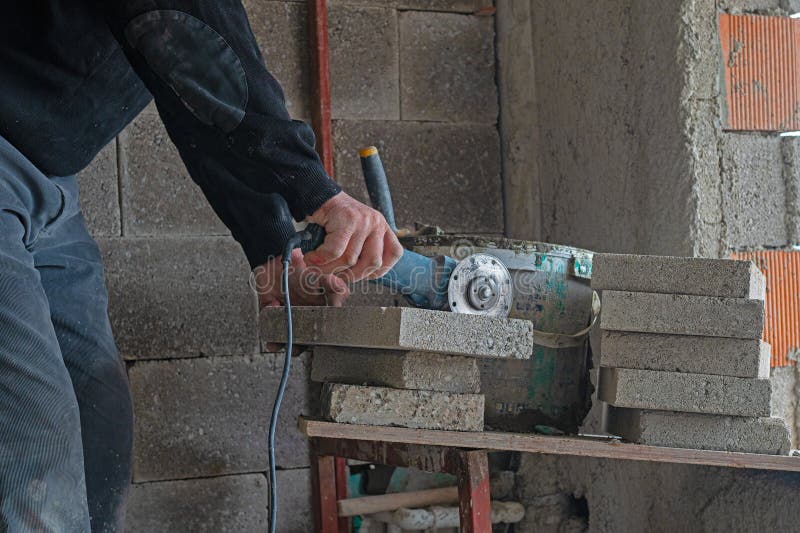 The Construction Foreman Cuts the Briquette with a Cutting Tool Stock ...