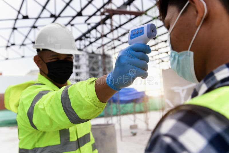 Screening Body Temperature of Worker with Infrared Thermometer Stock ...