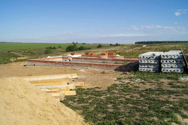 Construction of the Foundation for Building in Field on Background Blue ...
