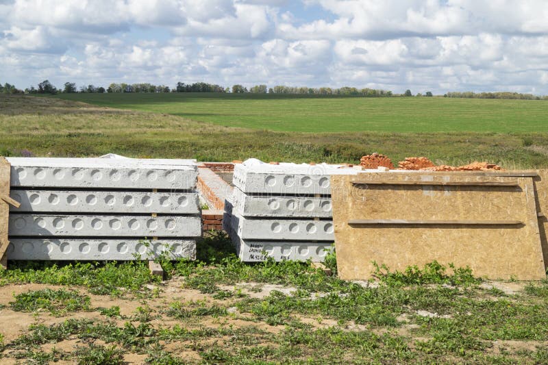 Construction of the Foundation for Building in Field on Background Blue ...