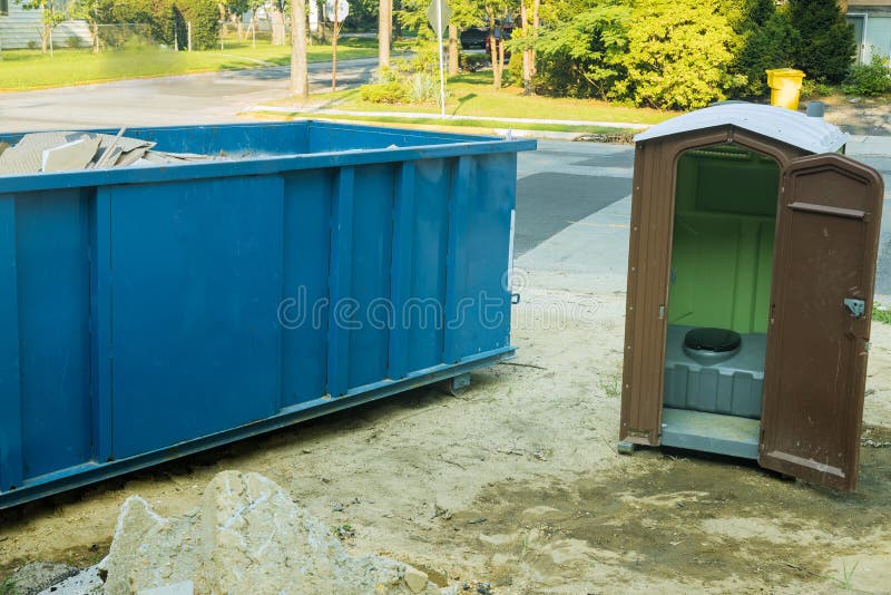 Construction Garbage Dumpster and Portable Restroom on New House Under ...
