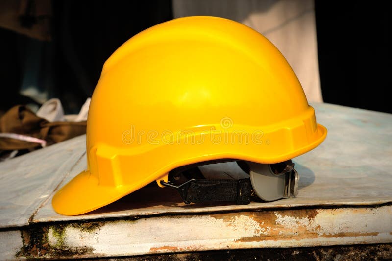 Green Safety Helmet on Foreground. Group of Four Construction Workers ...