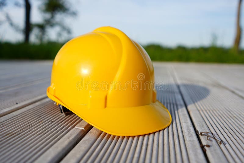 Construction Helmet on a Wooden Background. Yellow Hard Hat Stock Photo ...