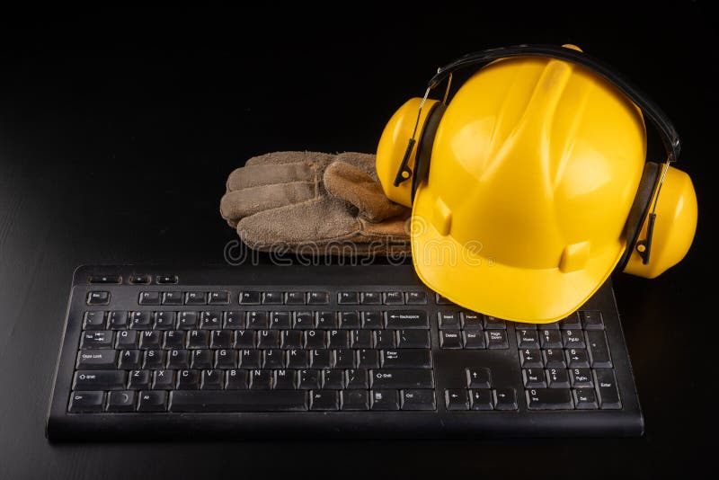 Construction Helmet, Work Gloves on the Computer Keyboard. Work Clothes ...
