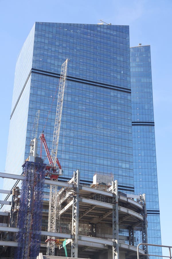Construction of a High Rise Building with a Crane in the Background ...