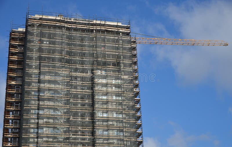 Construction of High-rise Building with Tower Crane Against Clear Blue ...
