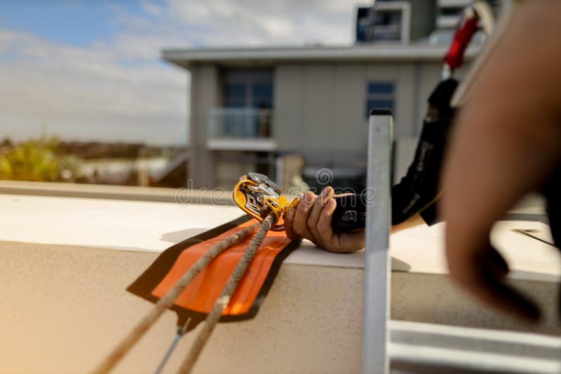 Industrial Rope Access Abseiler Window Cleaner Worker Bend Knees while ...