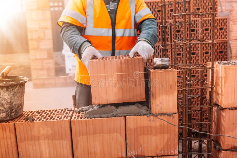 Industrial Bricklayer Installing Bricks on Construction Site Stock ...