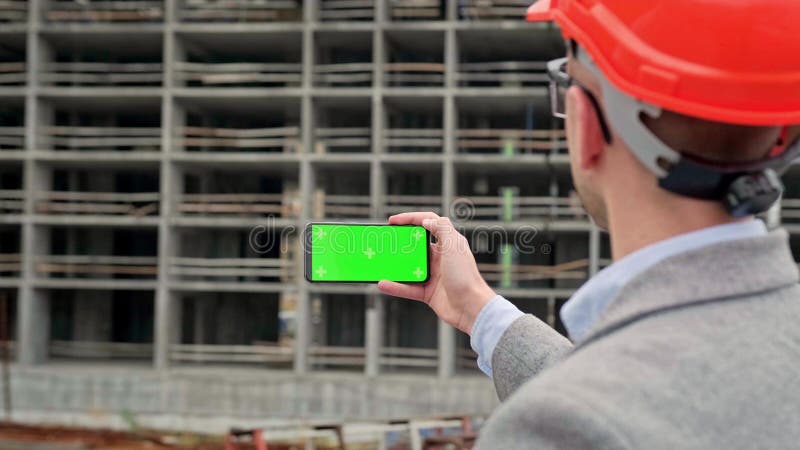 Construction Inspector Checking New Building Parameters with Smartphone ...