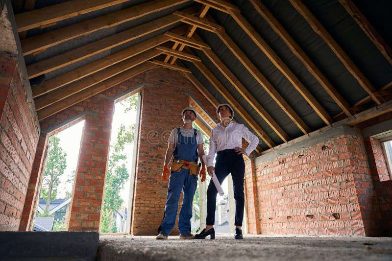 Construction Inspector and Contractor Performing Inspection of Building ...