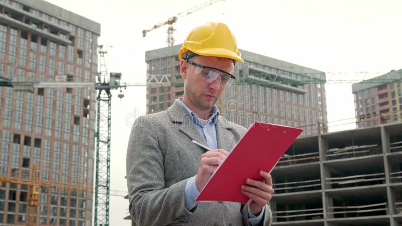 Construction Inspector Making Notes during Inspection of Building ...