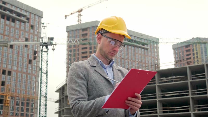 Construction Inspector Making Notes during Inspection of Building ...