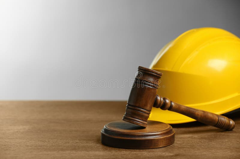 Construction and Land Law Concepts. Gavel and Hard Hat on Wooden Table ... Construction and Land Law Concepts. Gavel and Hard Hat on Wooden Table ...