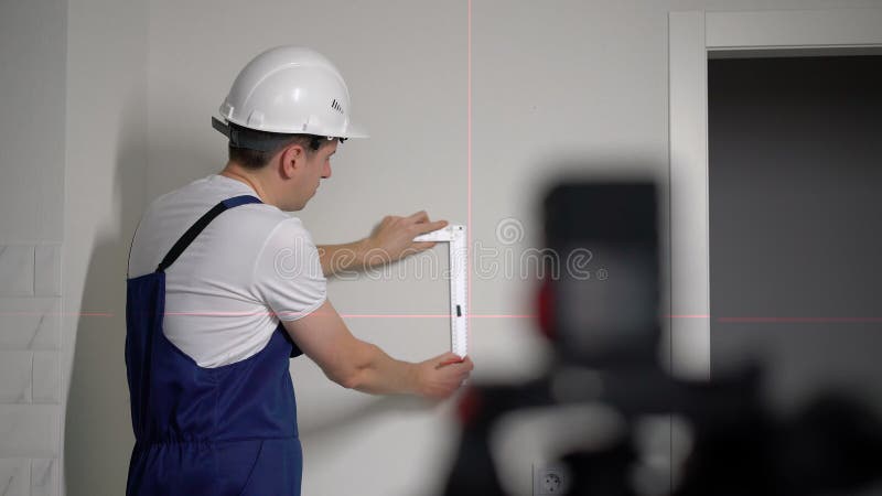 Construction Laser Level. Builder Worker Makes Repairs in the Apartment ...