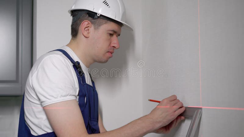 Construction Laser Level. Builder Worker Makes Repairs in the Apartment ...