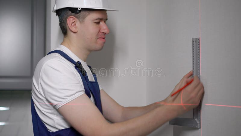 Construction Laser Level. Builder Worker Makes Repairs in the Apartment ...
