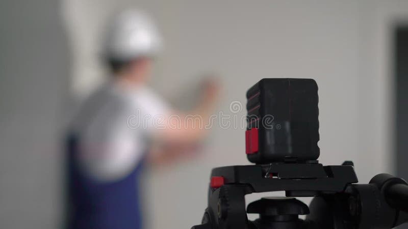 Construction Laser Level. Builder Worker Makes Repairs in the Apartment ...