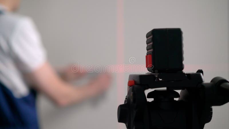 Construction Laser Level. Builder Worker Makes Repairs in the Apartment ...