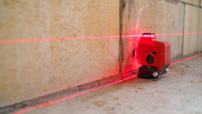 Construction Laser Level On A Wall Background. Apartment Renovation ...