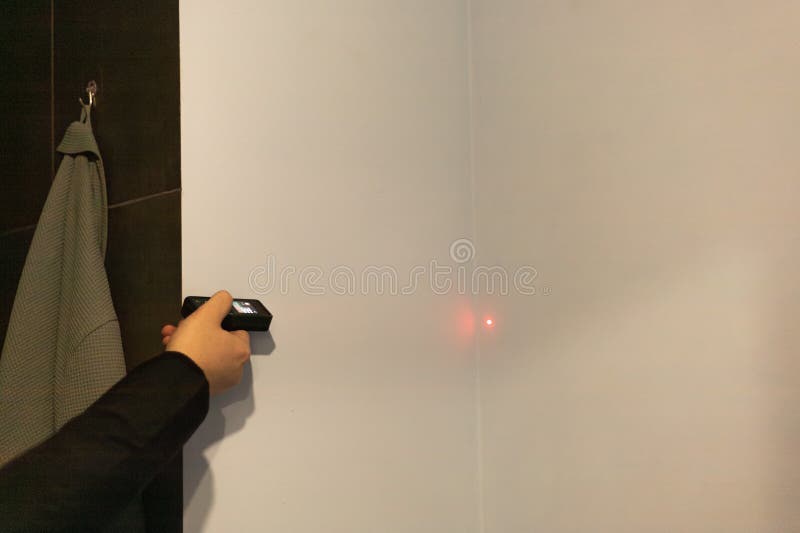 Construction Laser Tape Measure, Measuring the Length of the Wall Stock ...