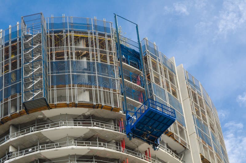 Construction Lift at Scaffolding on Building Site. Stock Image - Image ...