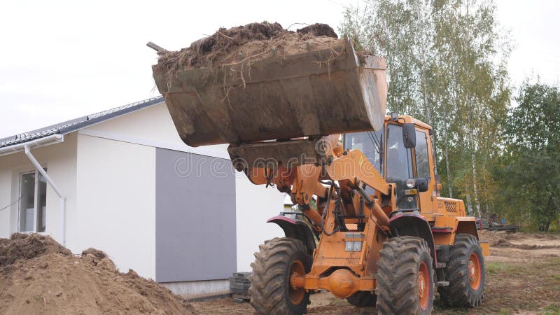 A Construction Loader is Actively Lifting Soil and Dirt at a ...