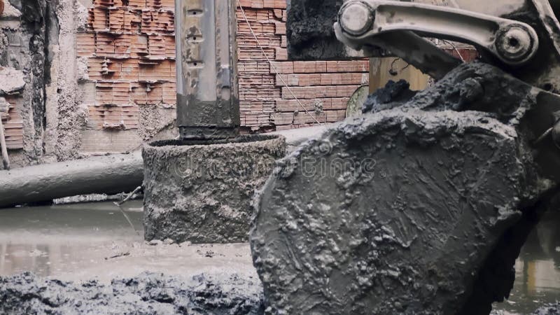 Construction Machine Pouring Concrete into the Foundation of a New ...